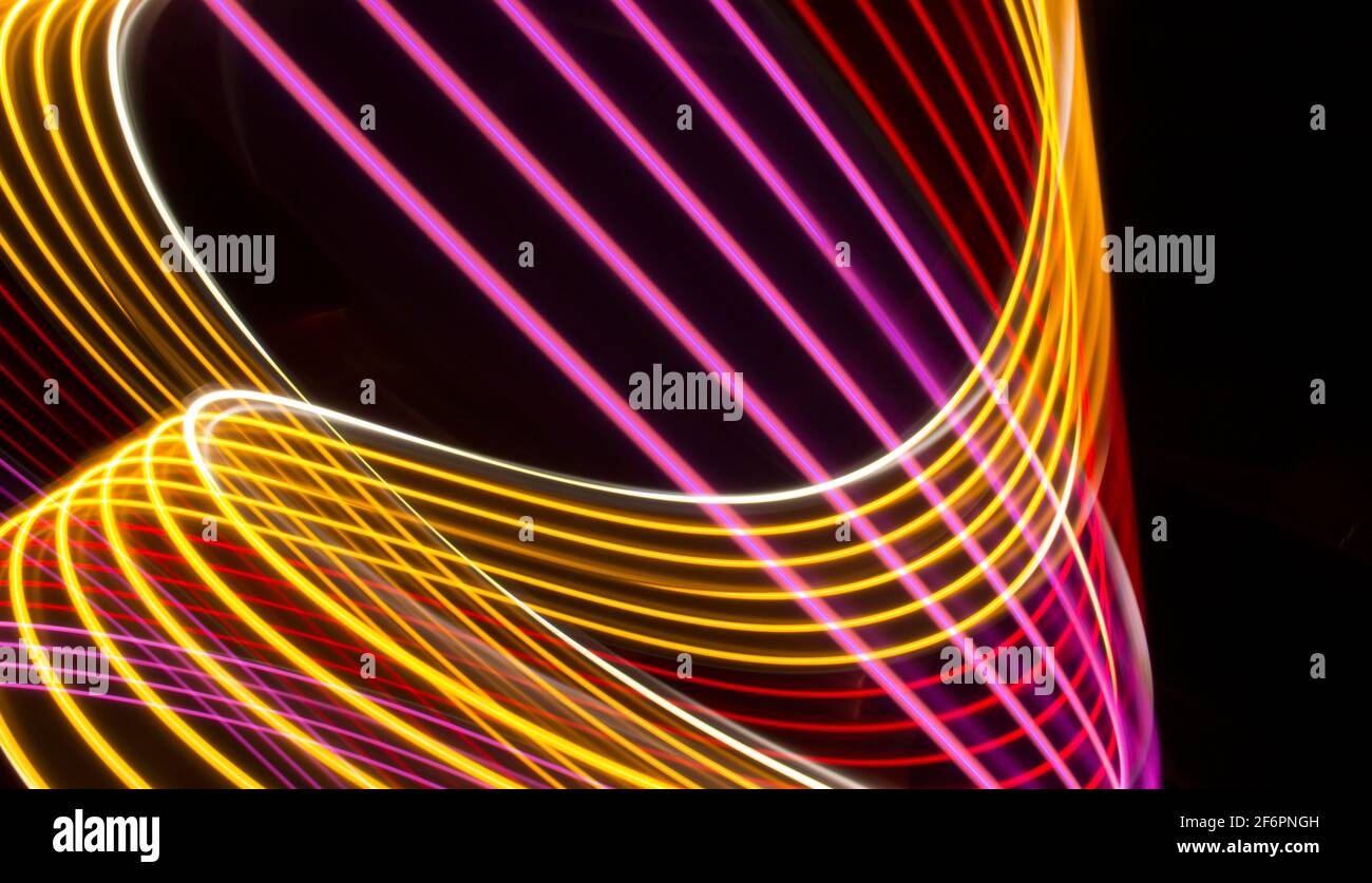 Yellow, red and pink light curve lines on a black background Stock ...