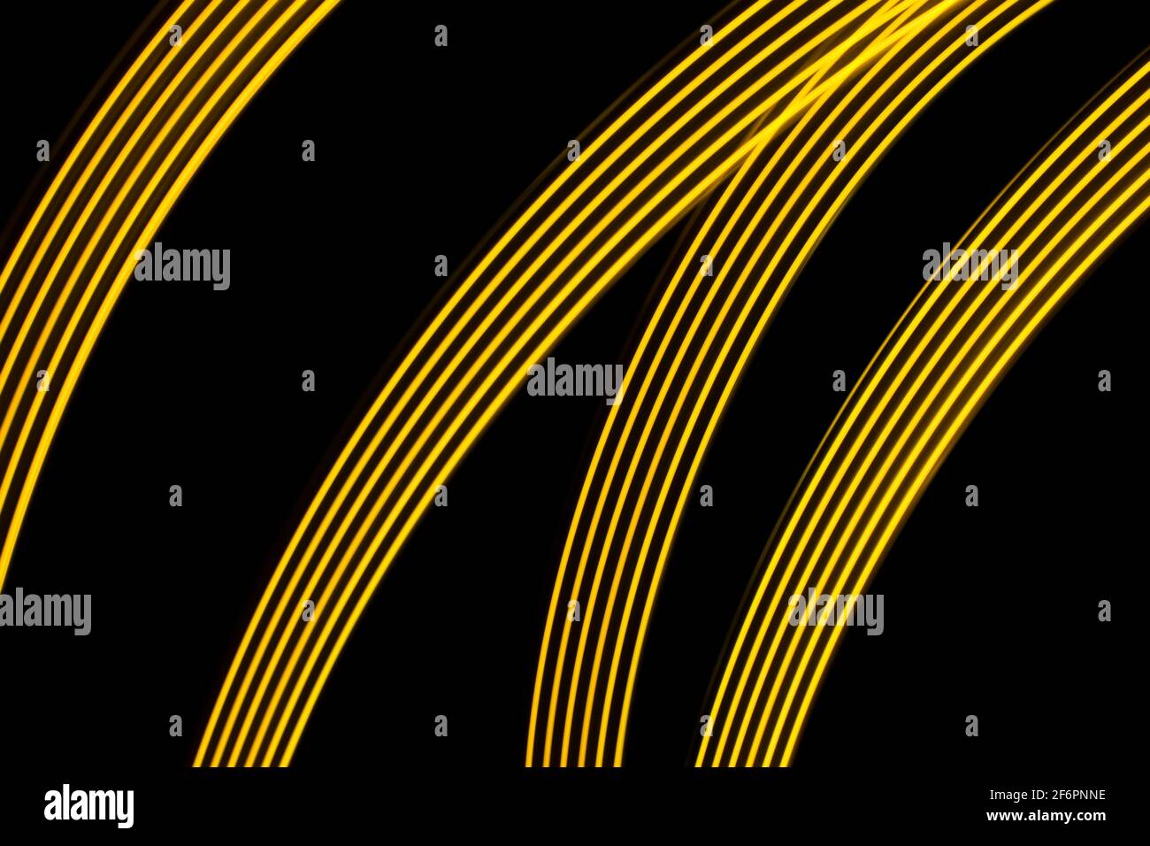 Yellow light lines on a black background Stock Photo - Alamy