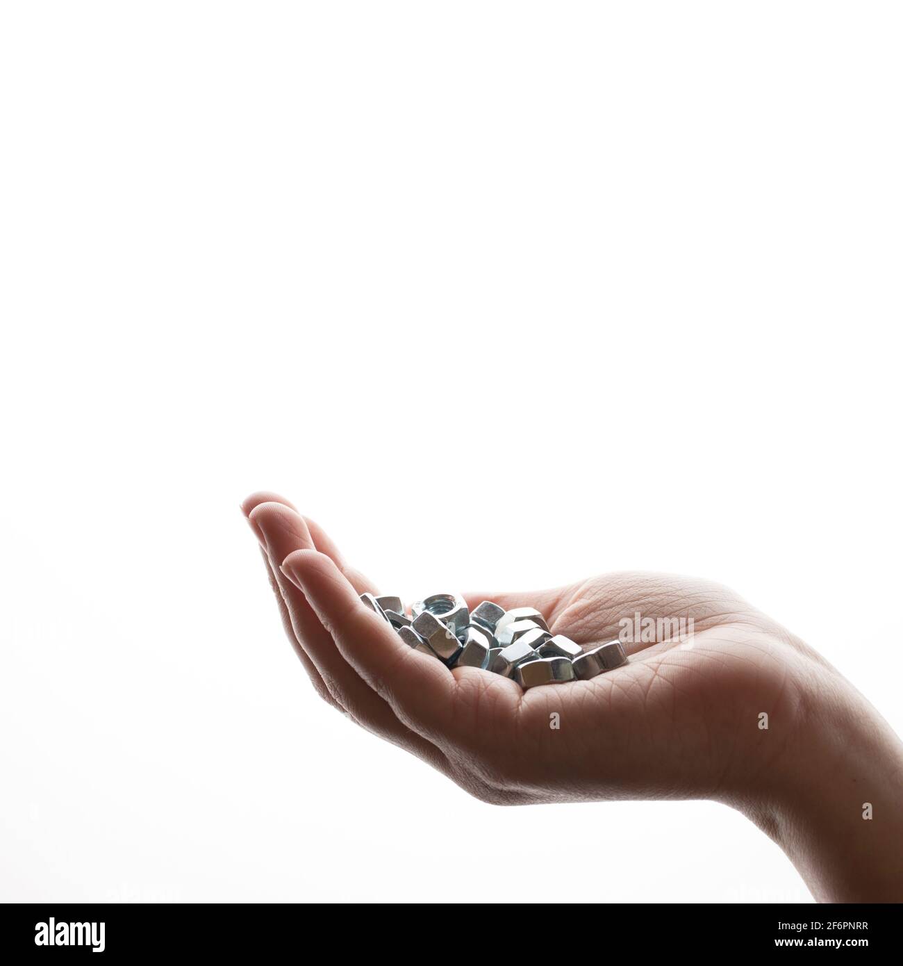 screw-nuts in hands on a white background Stock Photo - Alamy