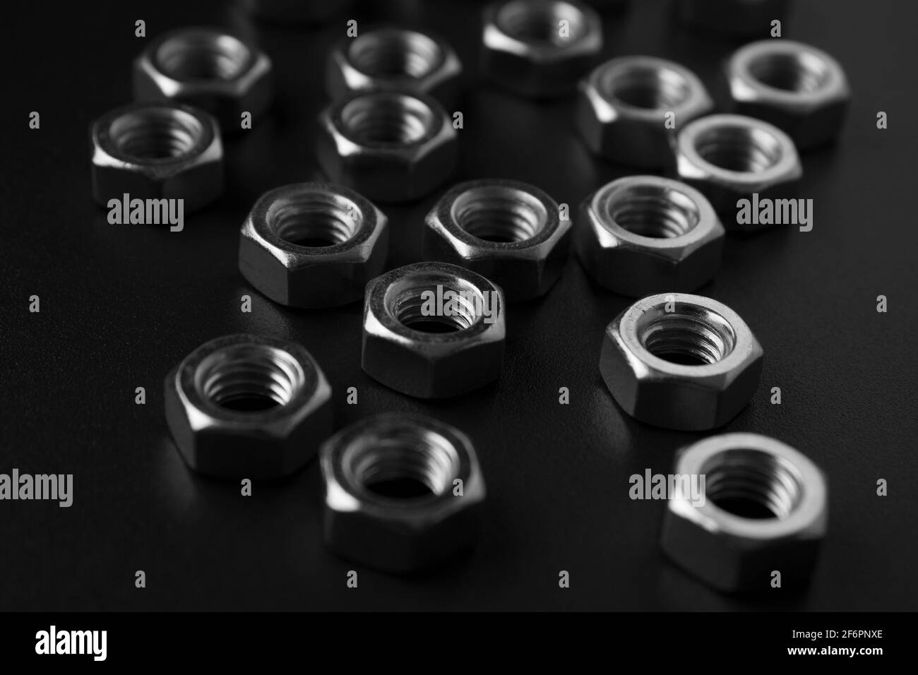 screw-nuts on a dark surface Stock Photo - Alamy