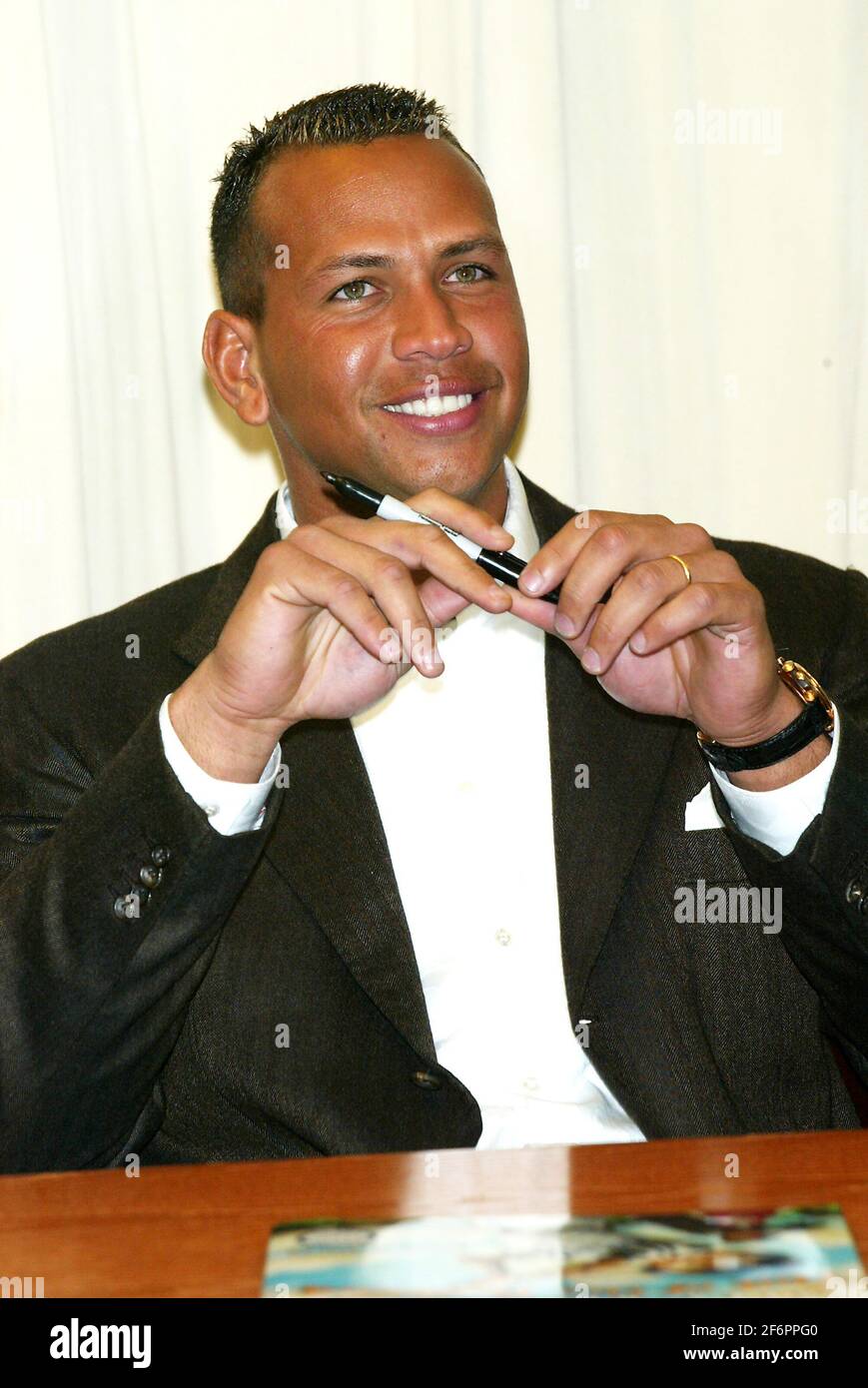 Alex Rodriguez ("A-Rod") poses for pictures before signing copies of ...