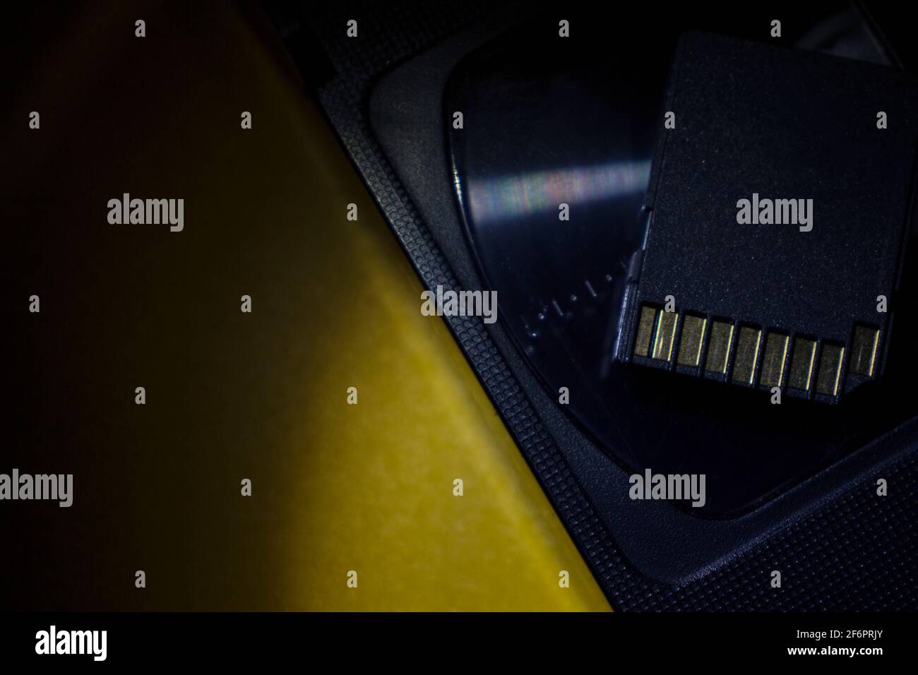 VHS cassette and SD card shot close up on a yellow background Stock ...