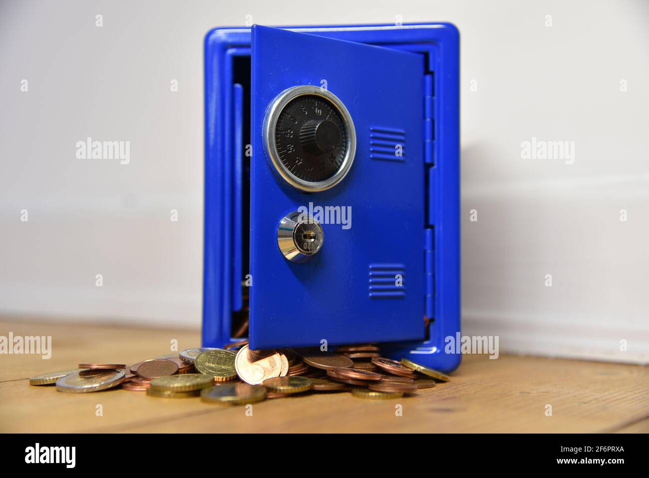 coins in a blue safe on a wodden floor Stock Photo - Alamy