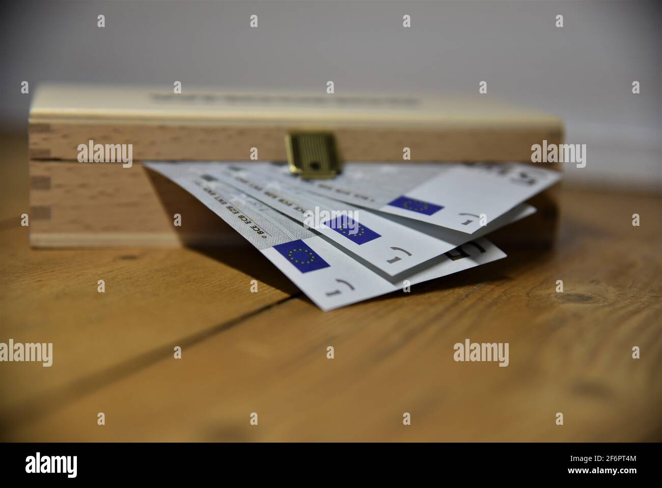 german euro bank notes on the floor with various items like a wallet, a ...