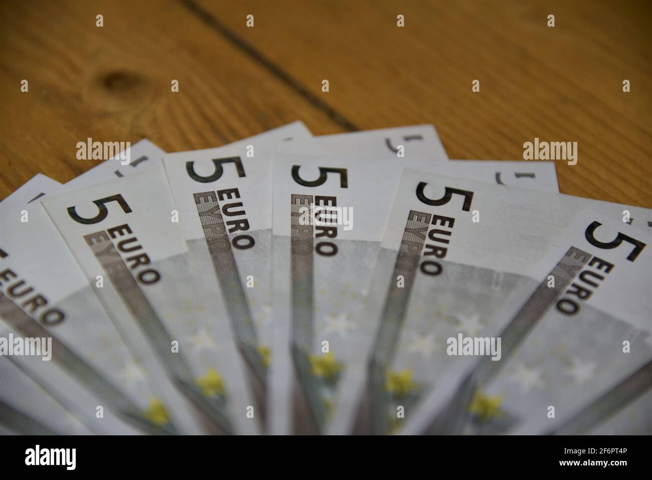 german euro bank notes on the floor with various items like a wallet, a ...