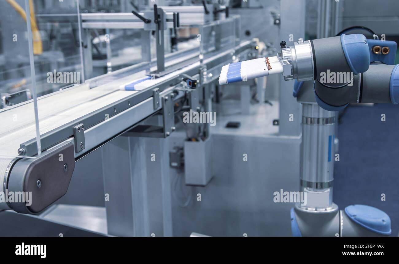 Automated robotic arm load aluminum cosmetic tube to filling machine in ...