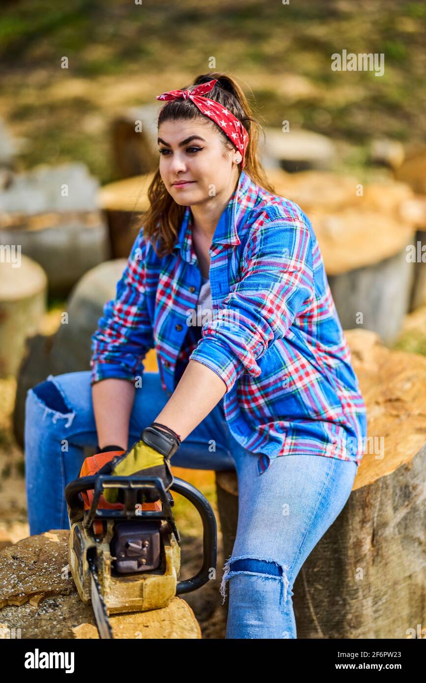 woman woodcutter rests on a log after hard work Stock Photo - Alamy