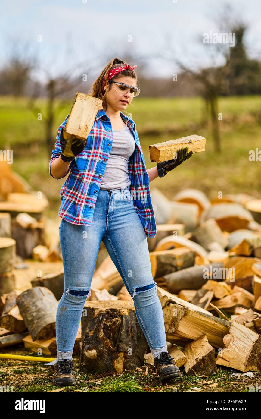 A Happy young woman collecting firewood Stock Photo - Alamy