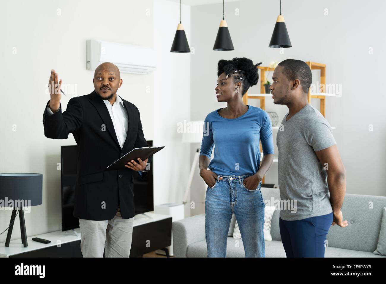 Agent Showing New Real Estate To African Couple Stock Photo - Alamy