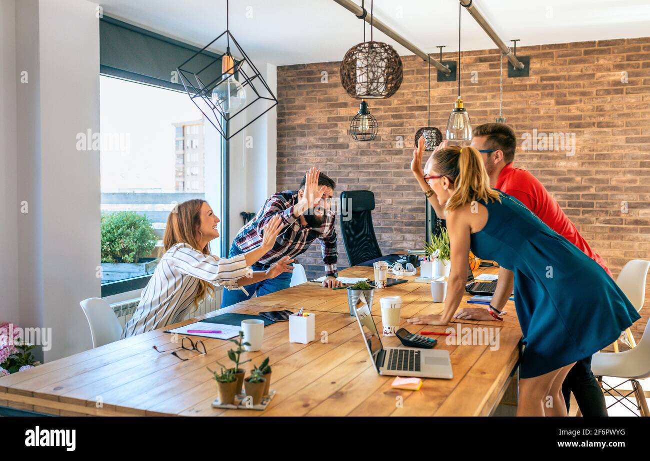 Colleagues celebrating success high hi-res stock photography and images ...
