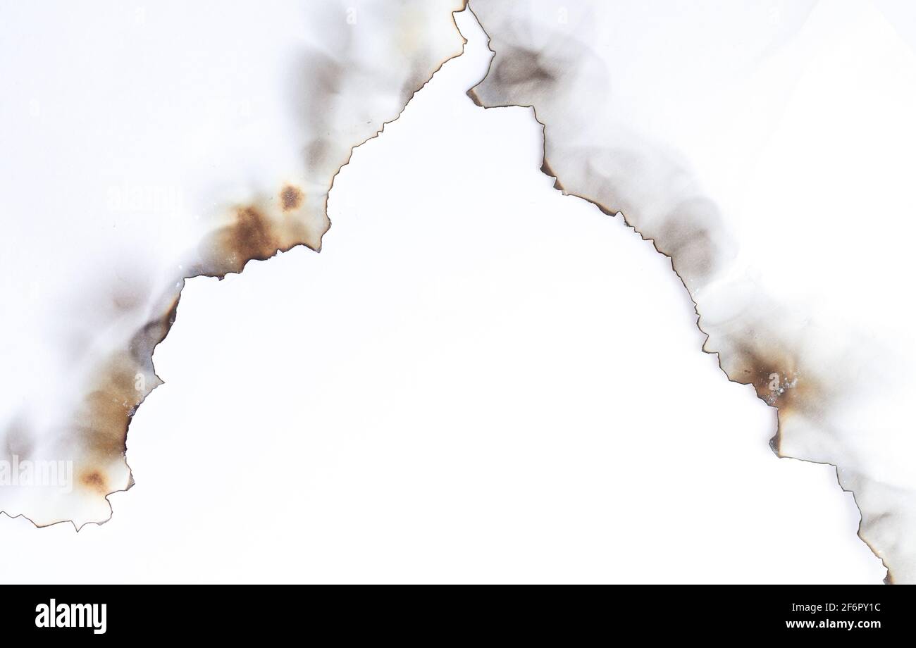 Burnt old torn paper on white background with copy space Stock Photo ...