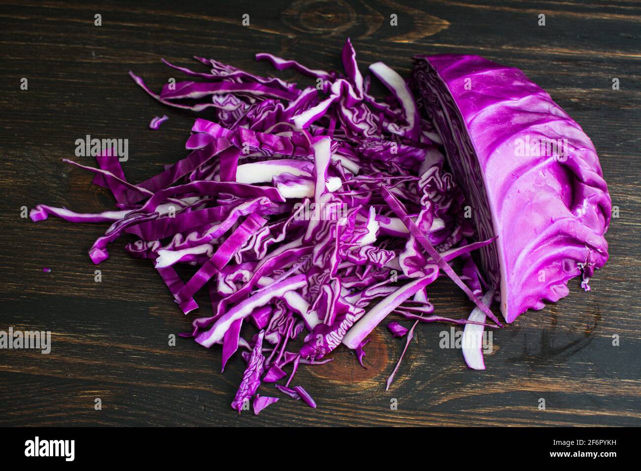 Shredded Red Cabbage on a Dark Wood Background: Sliced purple cabbage ...