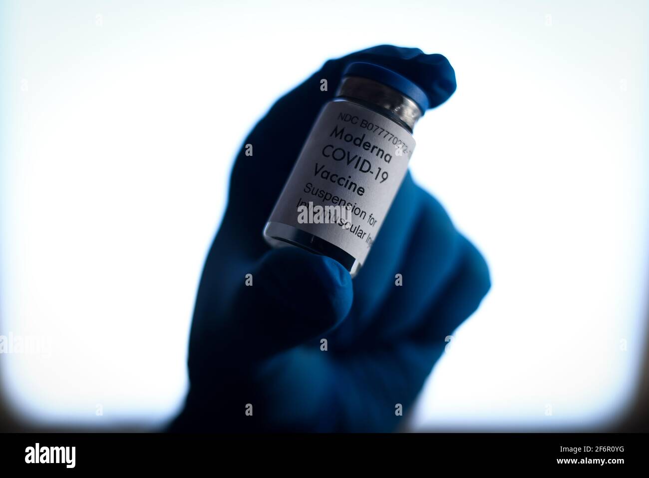 A vial with a Moderna label is seen with a syringe and needle in this ...
