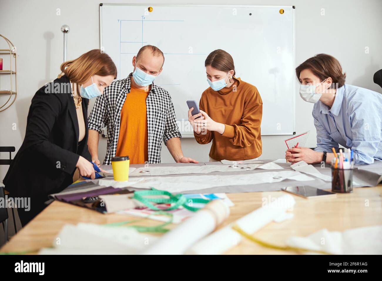 Group of fashion designers working with fabric Stock Photo - Alamy