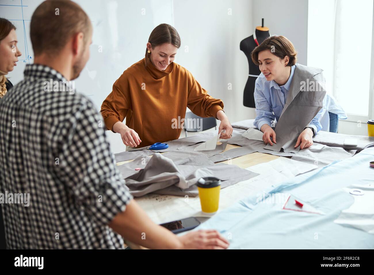 Woman picking up clothes from hi-res stock photography and images - Alamy