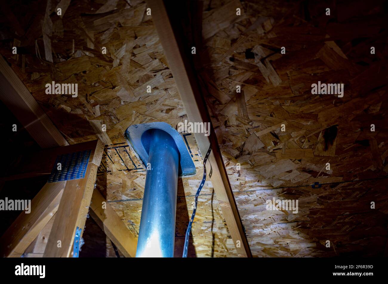 Attic view of installation of a galvanized vent pipe through a roof ...