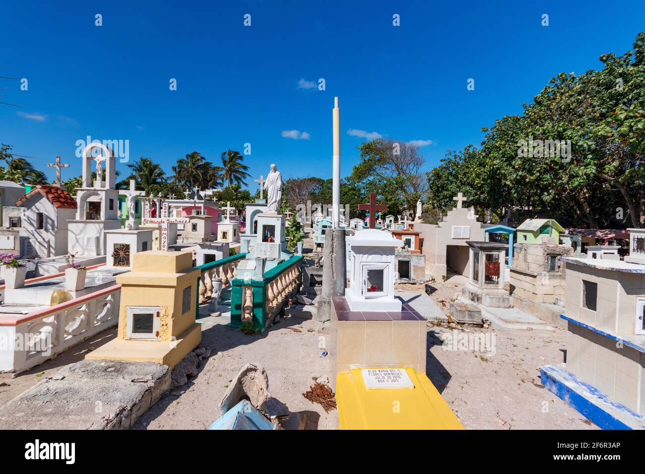 Colorful and elaborate monuments in a Mexican cemetery. People of ...