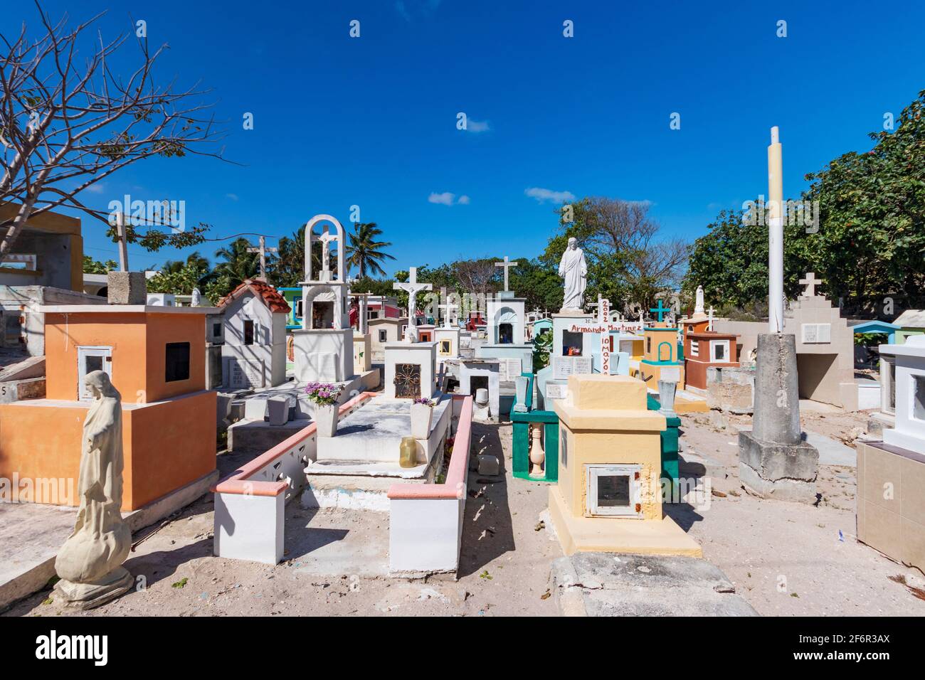 Colorful and elaborate monuments in a Mexican cemetery. People of ...