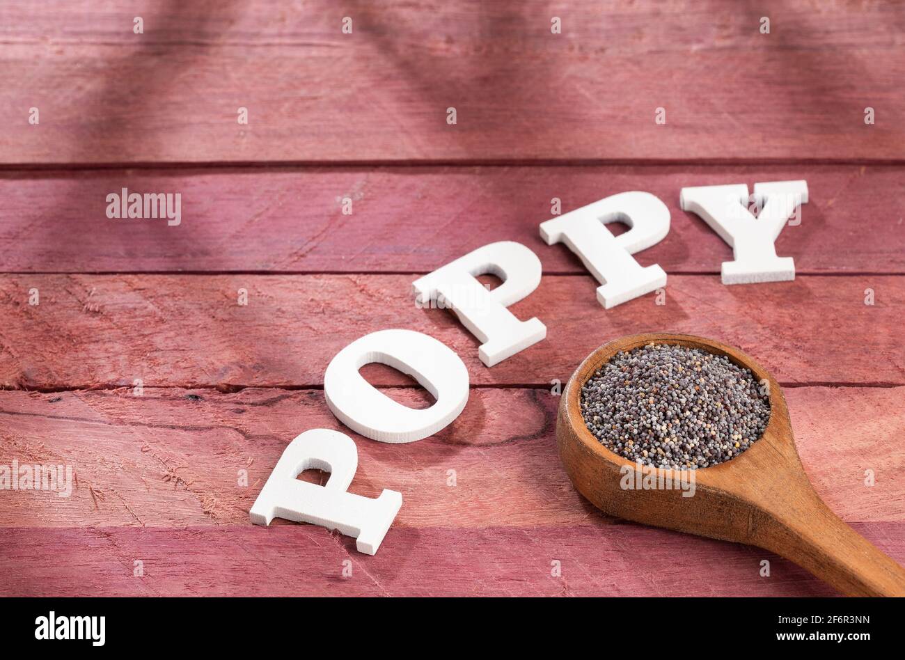 Organic poppy seeds - Papaver somniferum. The word poppy in letters ...