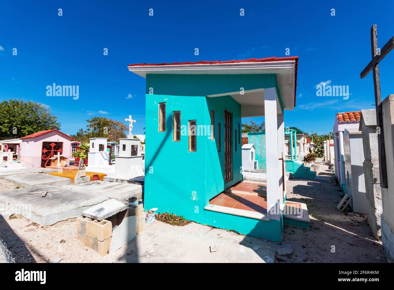 Colorful and elaborate monuments in a Mexican cemetery. People of ...