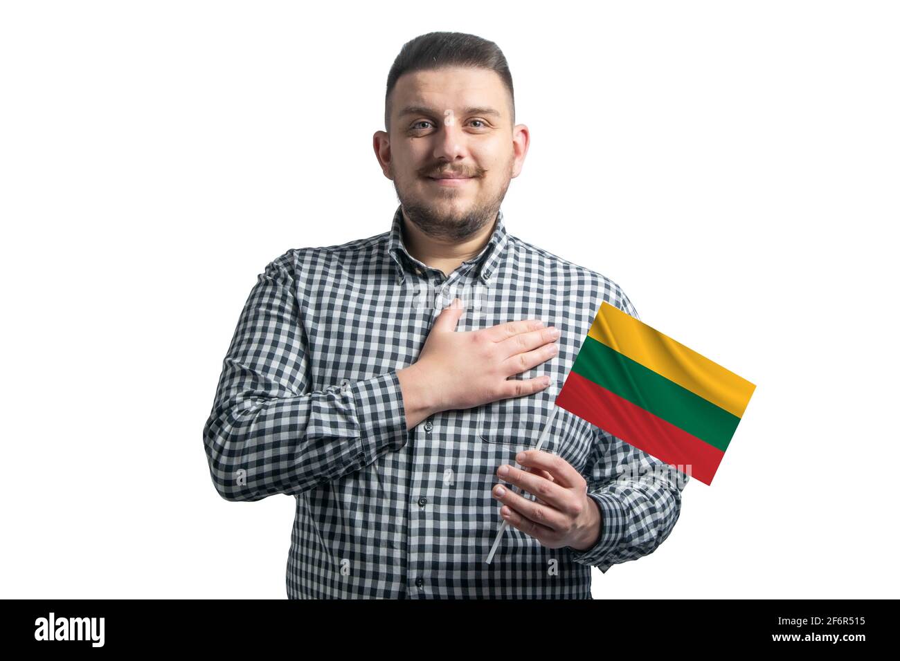 White guy holding a flag of Lithuania and holds his hand on his heart ...