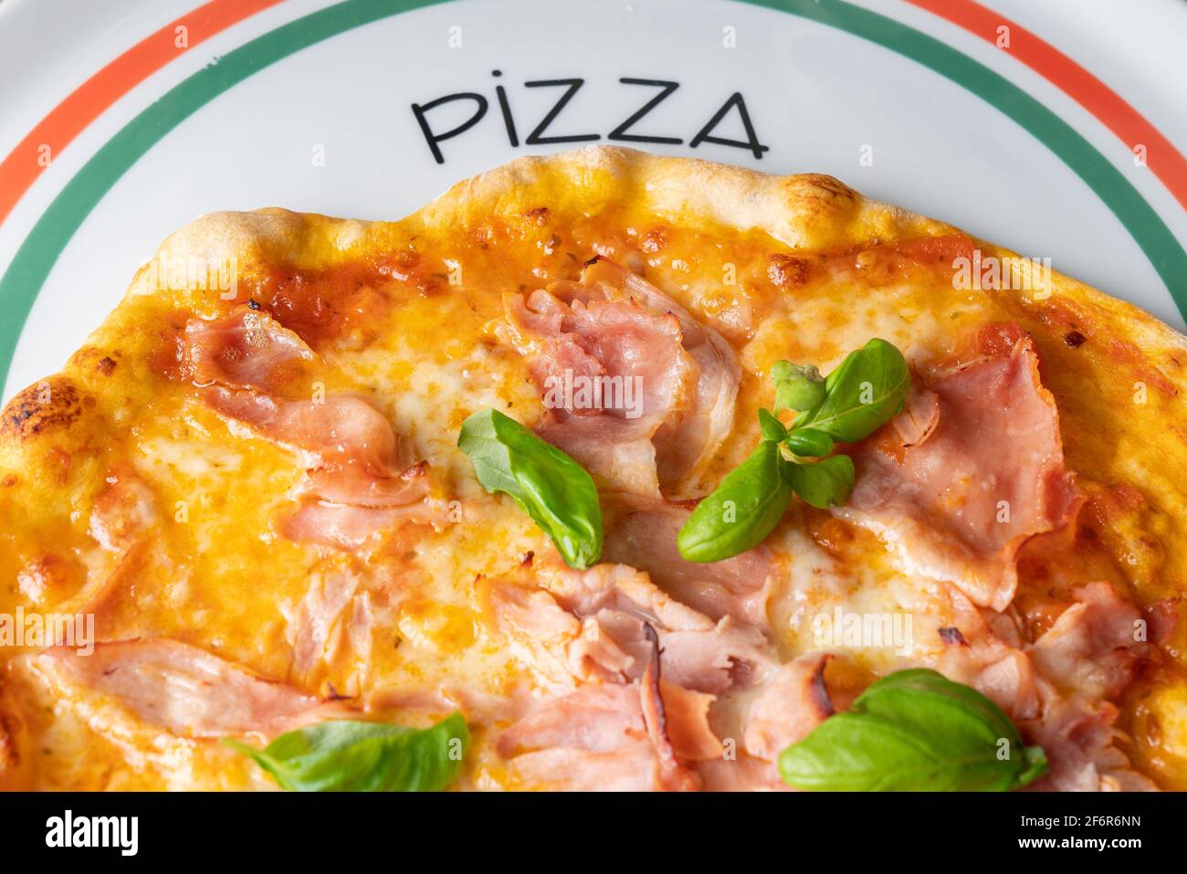 Fresh italian pizza with cheese(mozzarella), tomato, ham and small ...