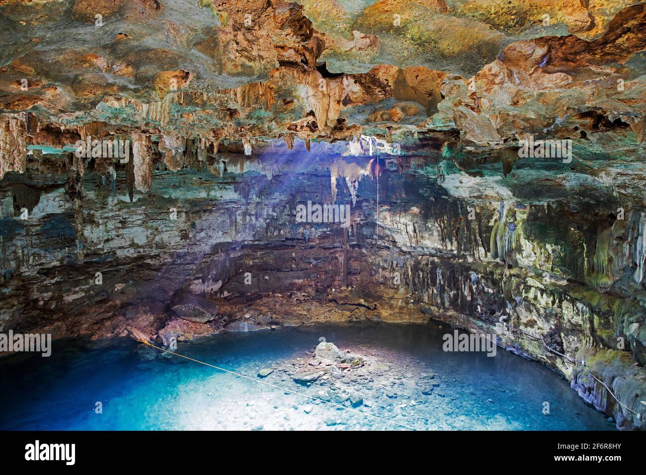 Cenote Xkeken / Cenote Dzitnup, blue pool in a limestone cave near ...