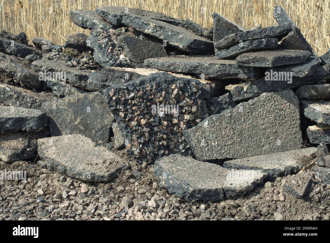 The asphalt pavement removed from the road lies in large chunks on the ...