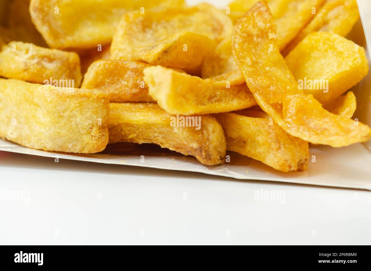 Deep fried and crispy delicious fries in a cardboard box, take away ...