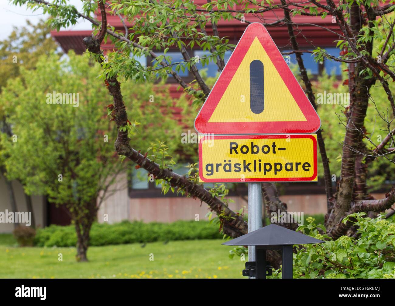 Traffic sign, next to lawn, which warns of robotic lawnmowers Stock ...
