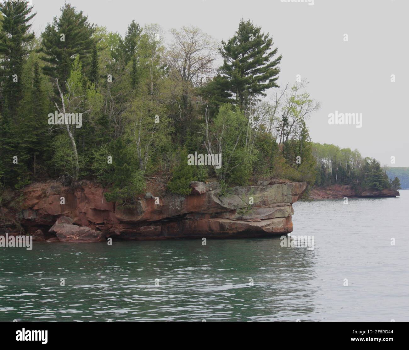 The Lake Superior rocky shoreline in Bayfield, Wisconsin, lined with ...