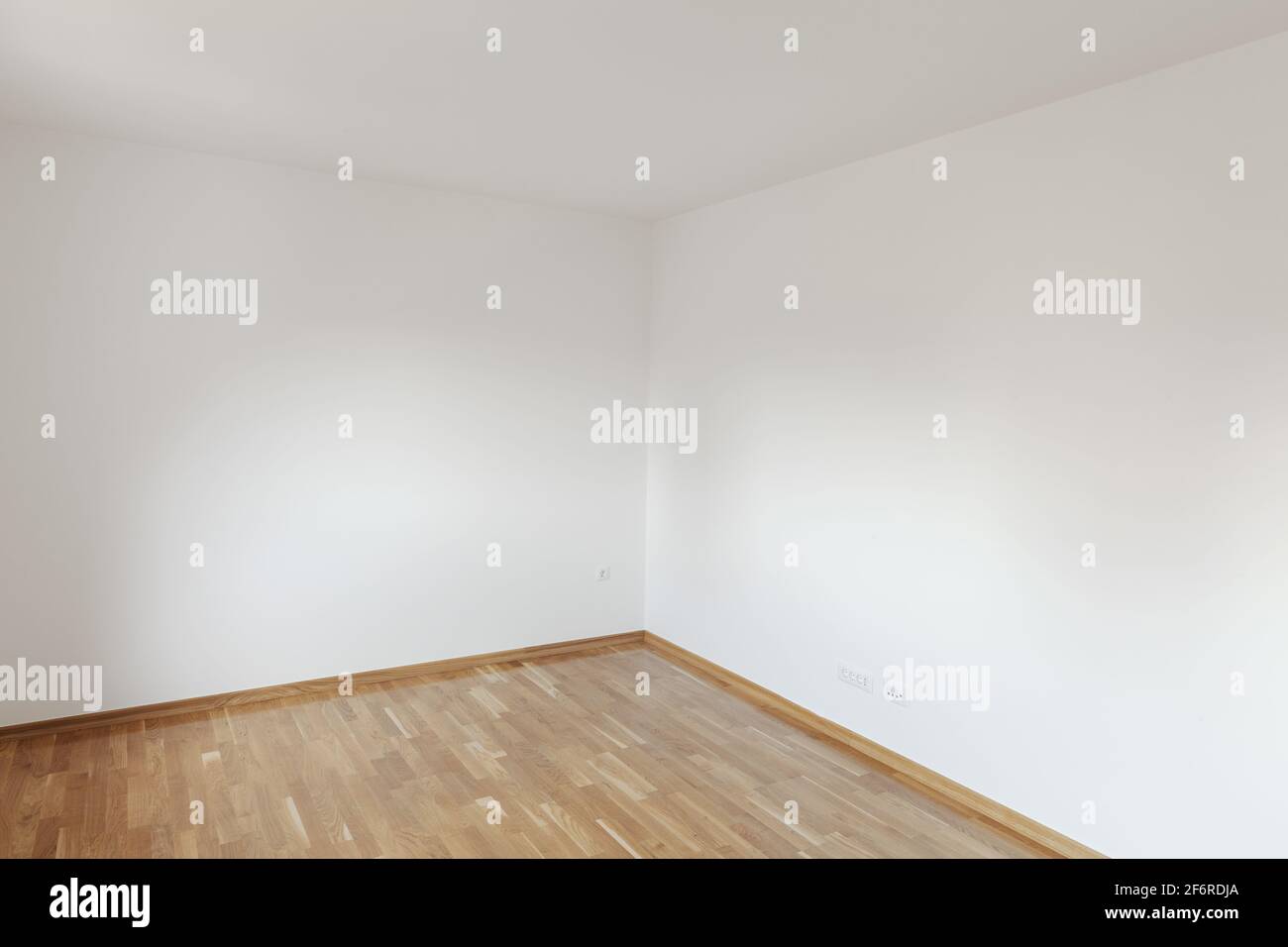 empty room with two white walls and parquet Stock Photo - Alamy
