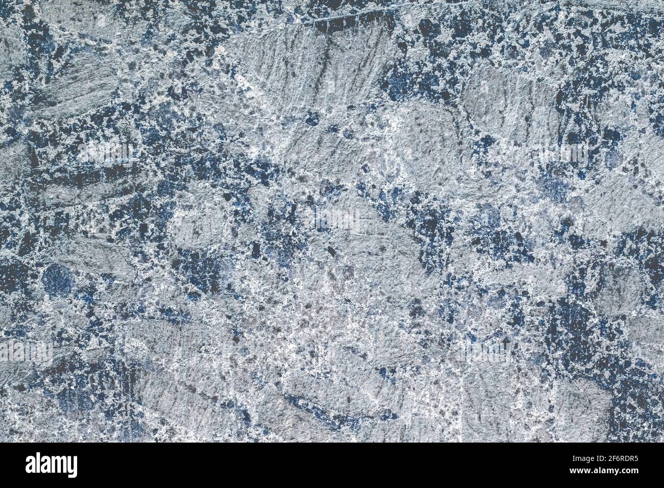 Light grey stone wall with dark blue abstract pattern texture ...