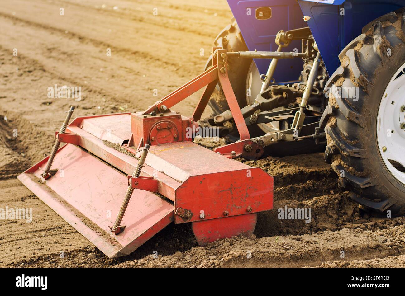 Tractor with milling machine loosens, grinds and mixes soil. Loosening ...