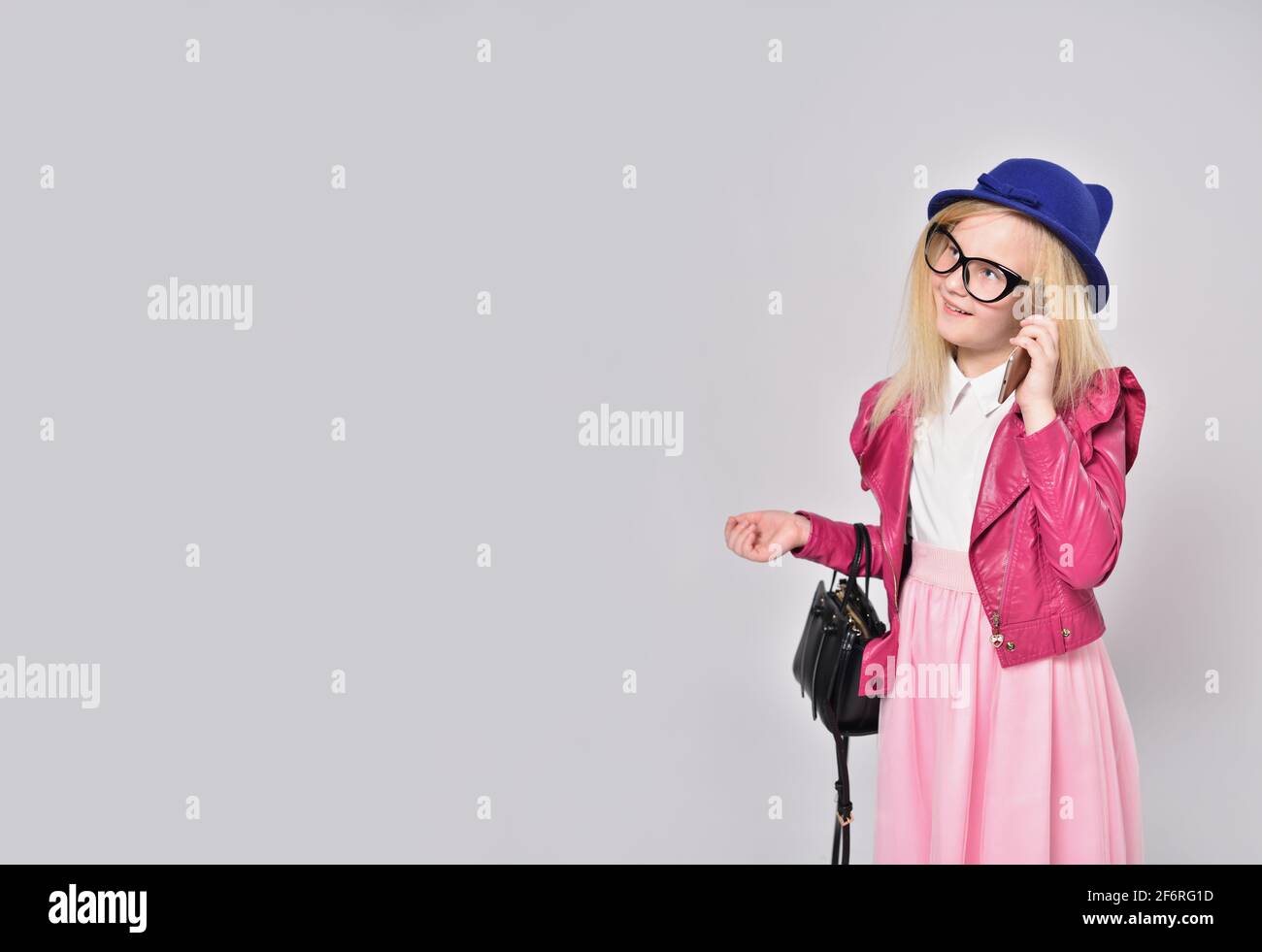 Child girl in a pink jacket talking on the phone Stock Photo - Alamy