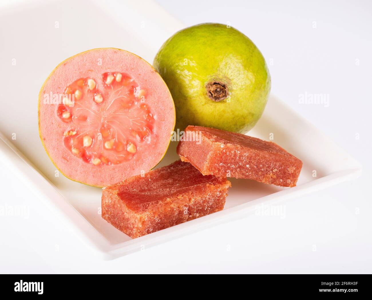 Guava fruit and paste on a white square plate Stock Photo - Alamy