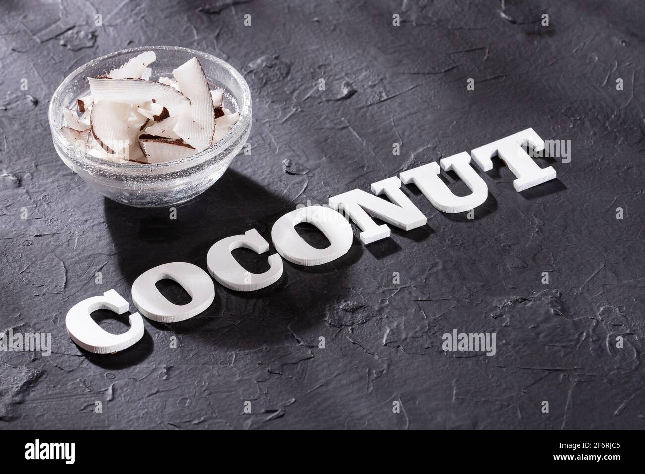 Grated coconut - Cocos nucifera. Word coconut in letters Stock Photo ...