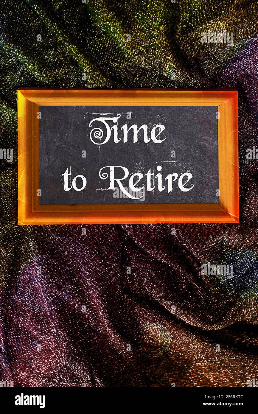 words TIME TO RETIRE on a black graphite board in a wooden frame ...