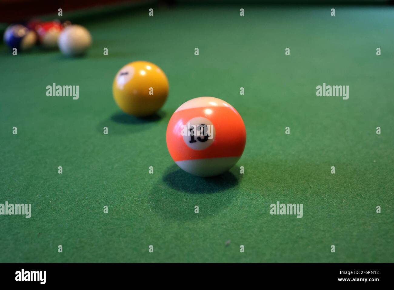 Colored pool balls on a green pool table. Billiard ball with number ...