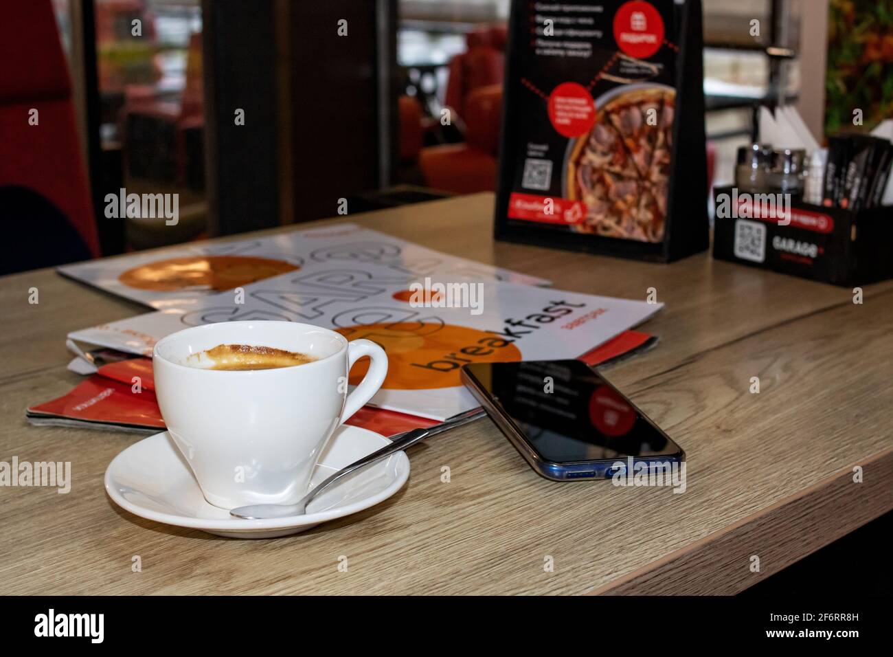 BELARUS, VITEBSK - SEPTEMBER 10, 2020: Cup of coffee and magazines on ...