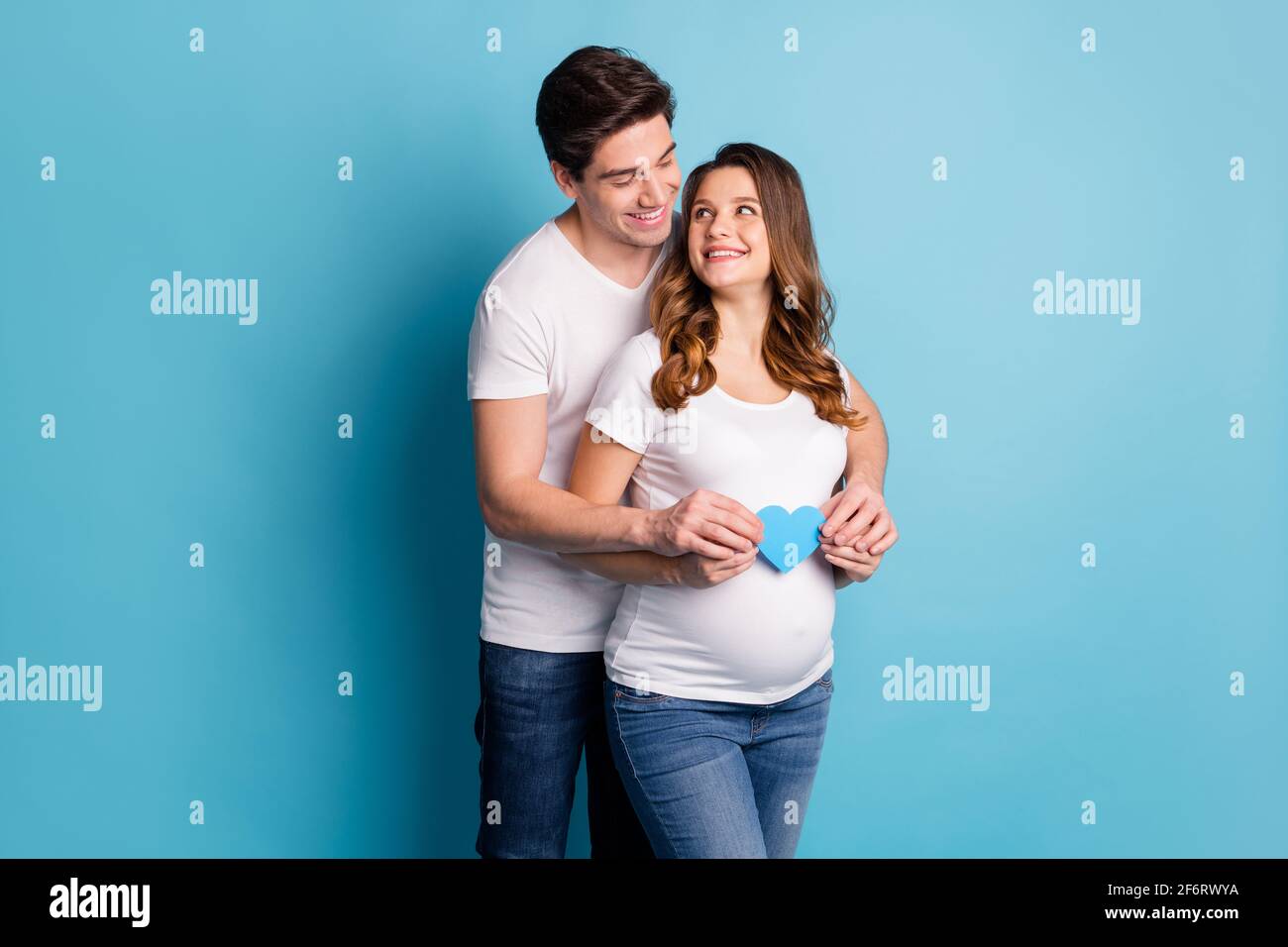 Photo of young happy positive smiling family look each other hold blue ...