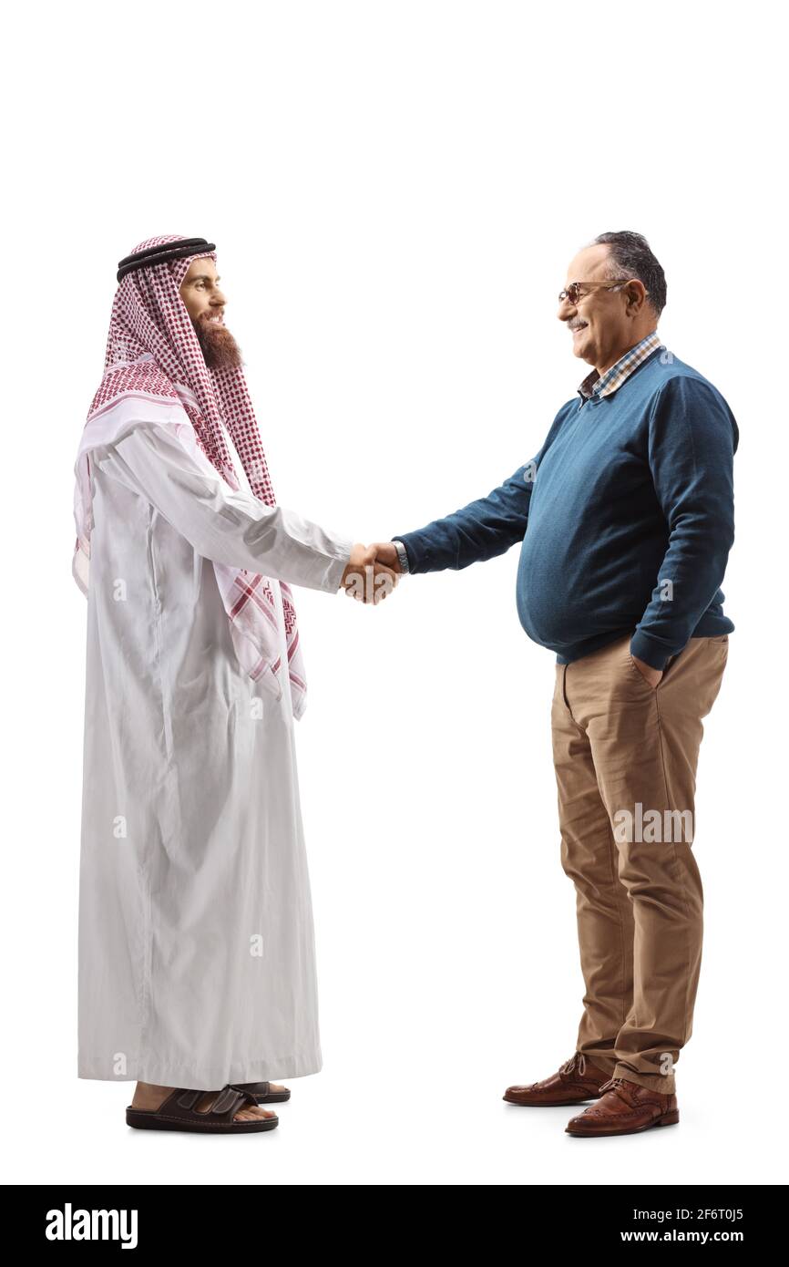 Full length profile shot of a young saudi arab man shaking hands with a ...