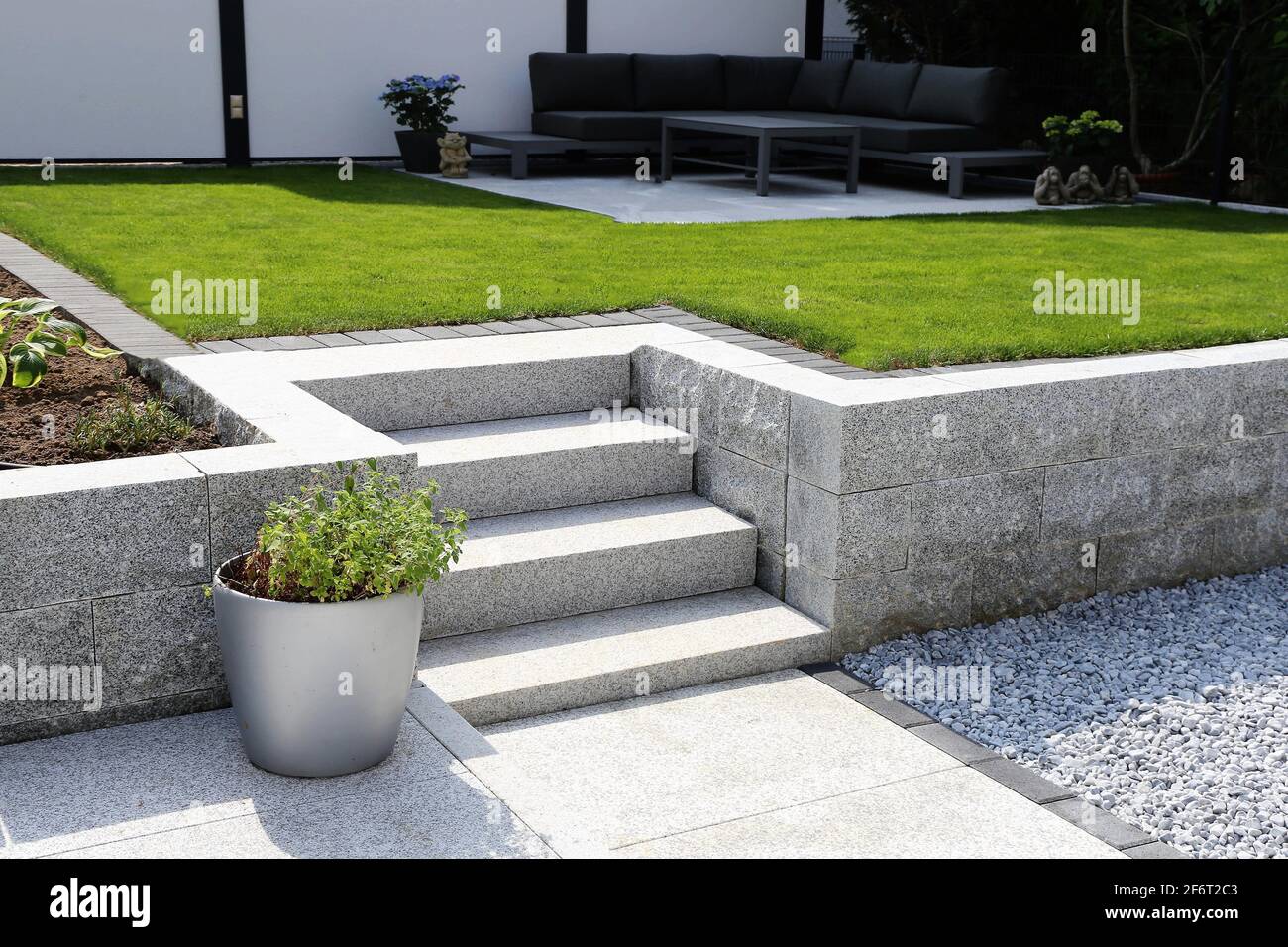 Neat and tidy garden with granite wall and solid block steps Stock ...