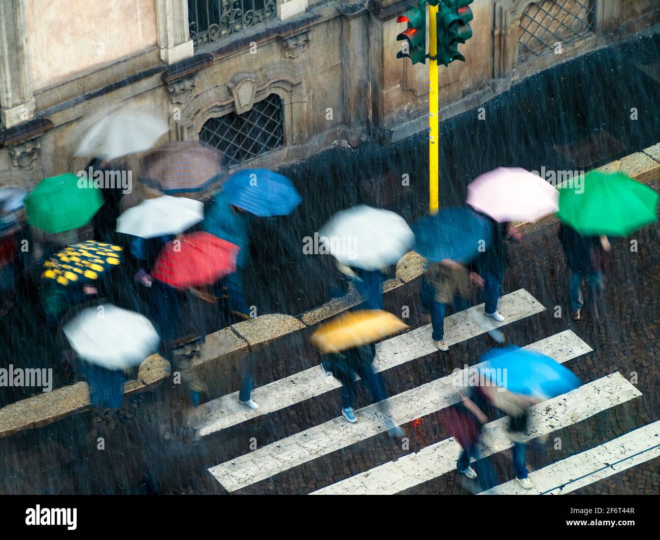 Pedestrians crossing under the rain Stock Photo - Alamy