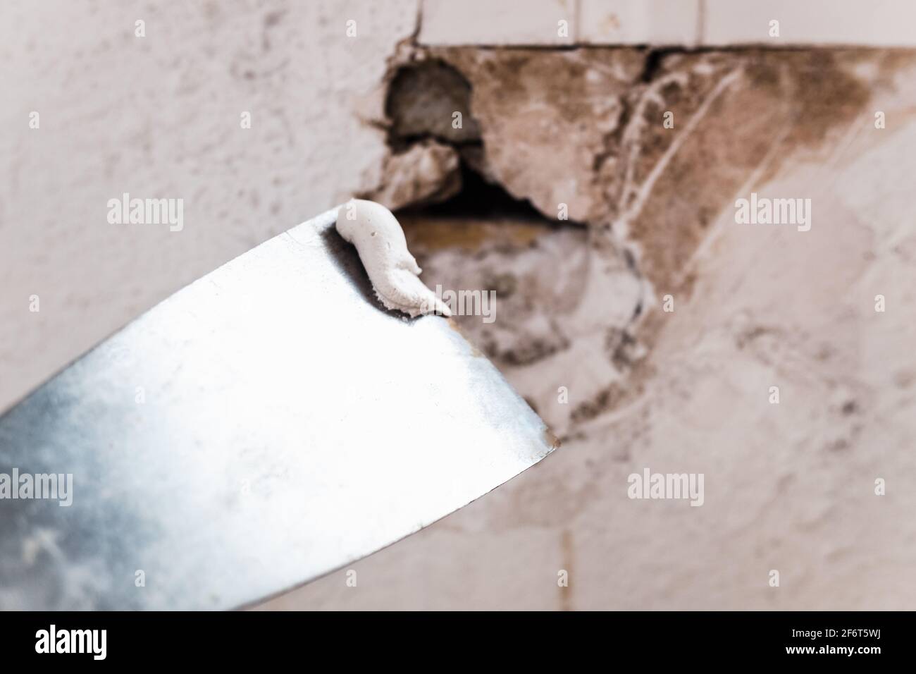 Detail of the repair of a hole in the wall of the living room using ...