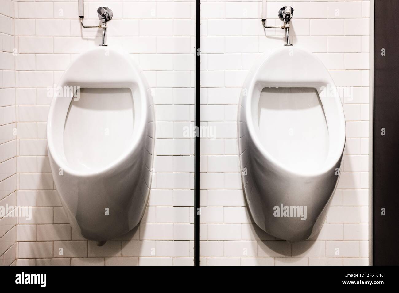 Two wall urinals in public toilets Stock Photo - Alamy