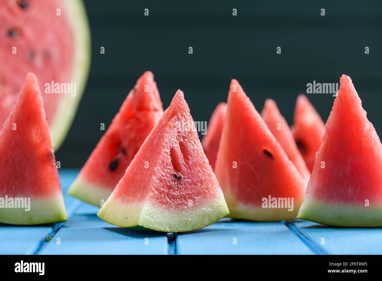 Many bright juicy watermelon slices cut into triangular shape. Summer ...