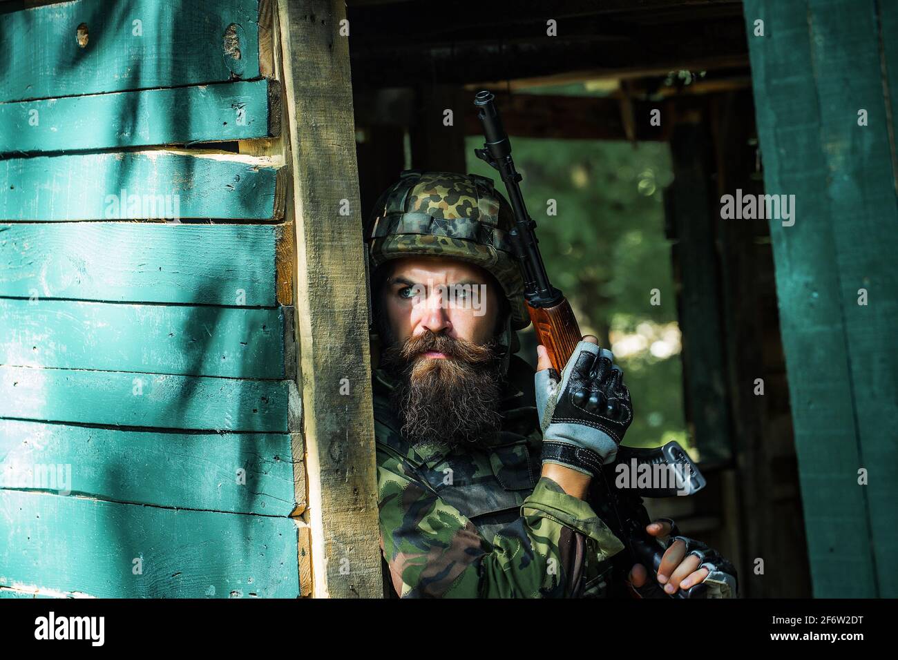 Portrait of bearded soldier in camouflage and gun Stock Photo - Alamy