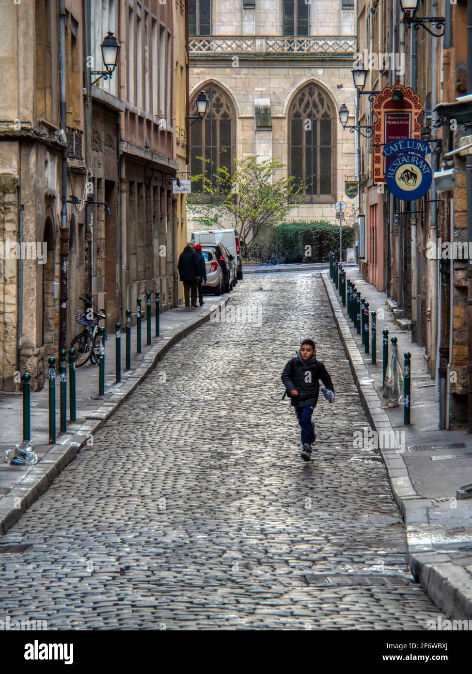 boy running on a cobblestone street, Lyon, France Stock Photo - Alamy