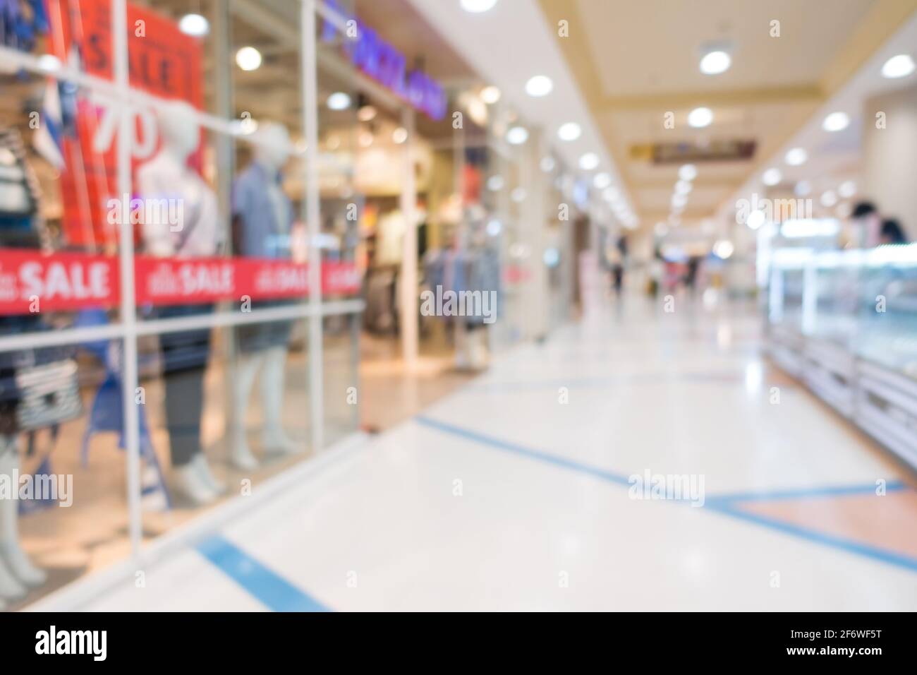 Blurred image of shopping mall and people walking for background usage ...